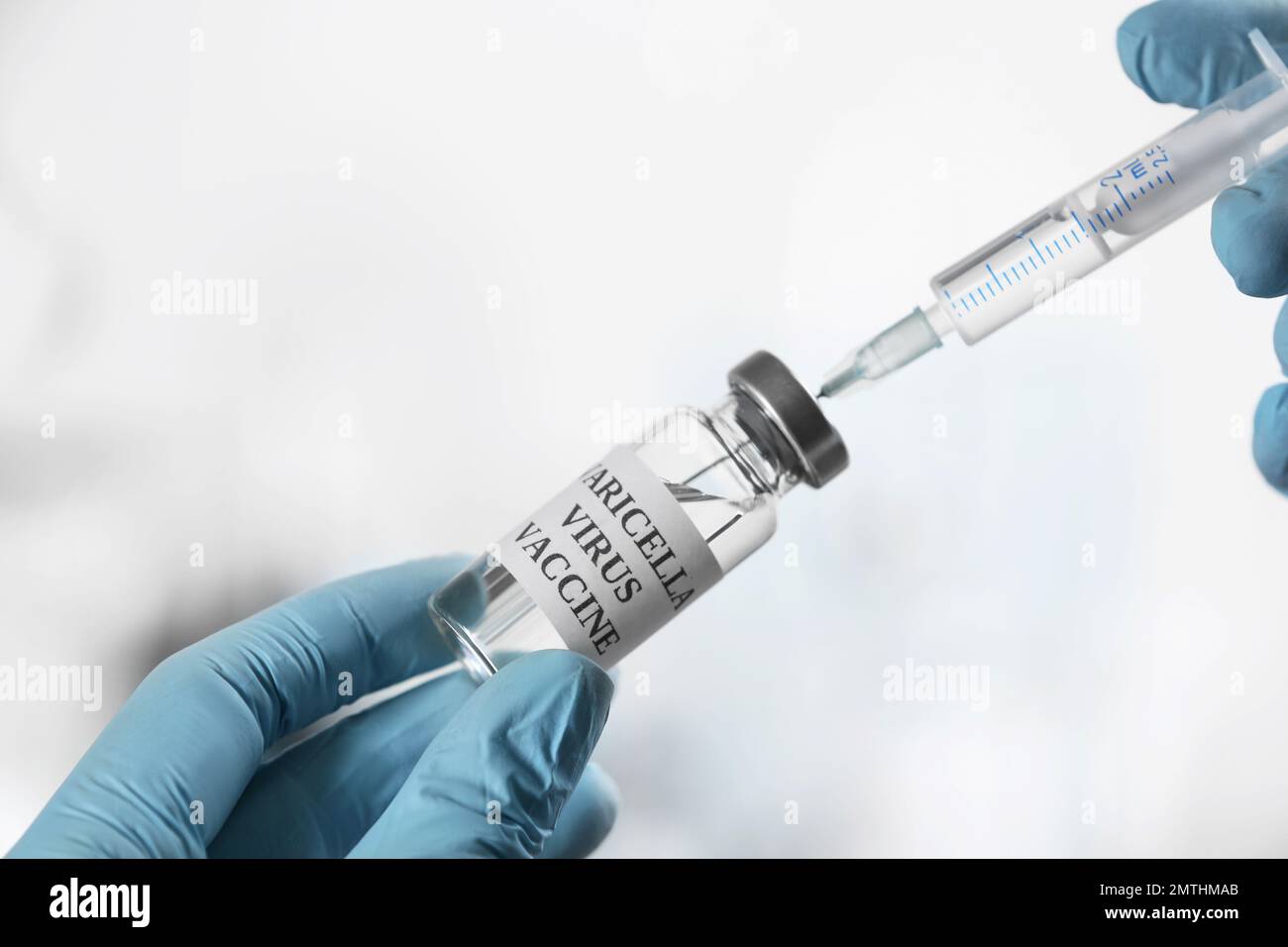 Doctor filling syringe with chickenpox vaccine indoors, closeup ...