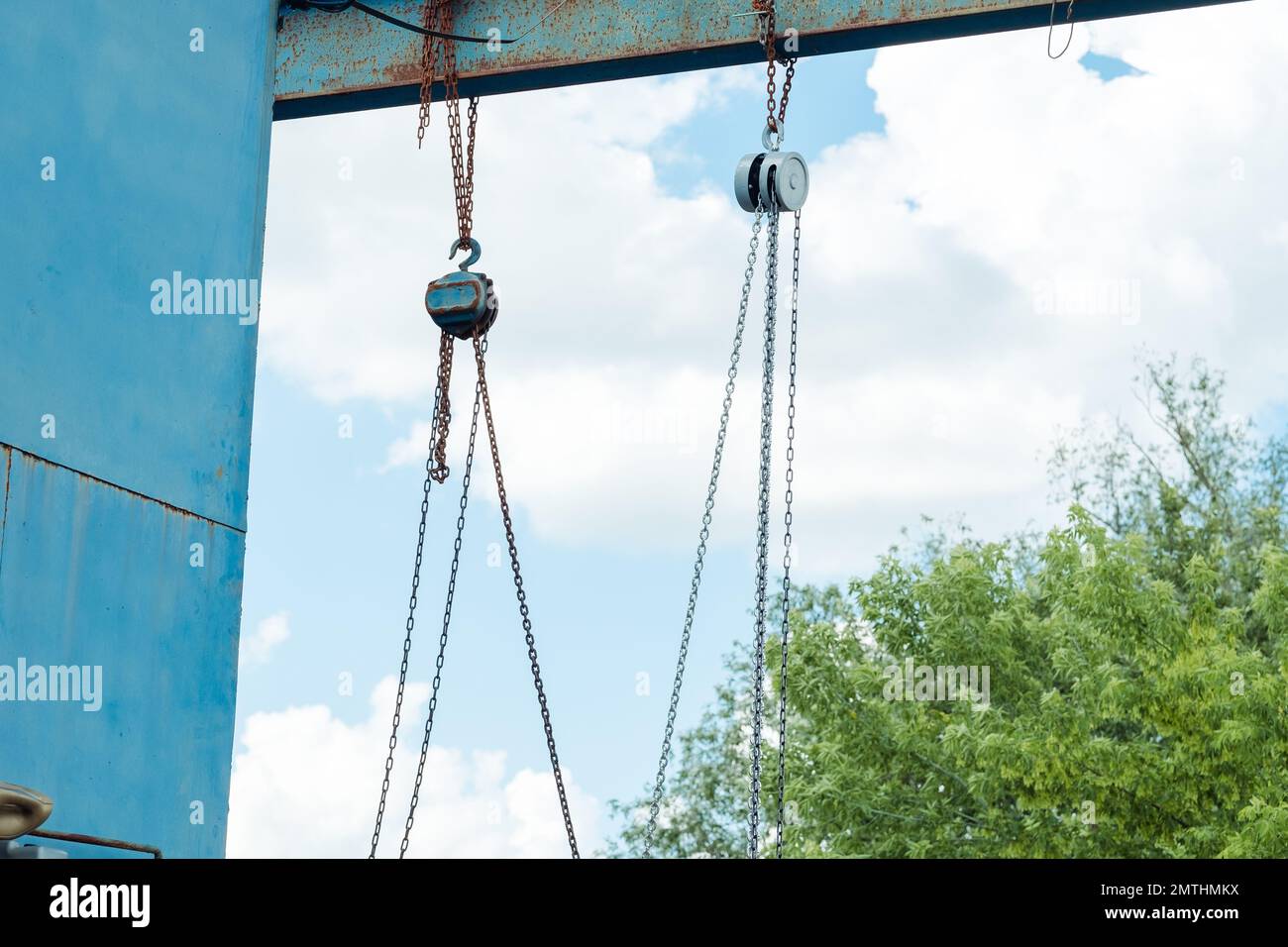 old iron structure with hook chains on the street Stock Photo - Alamy