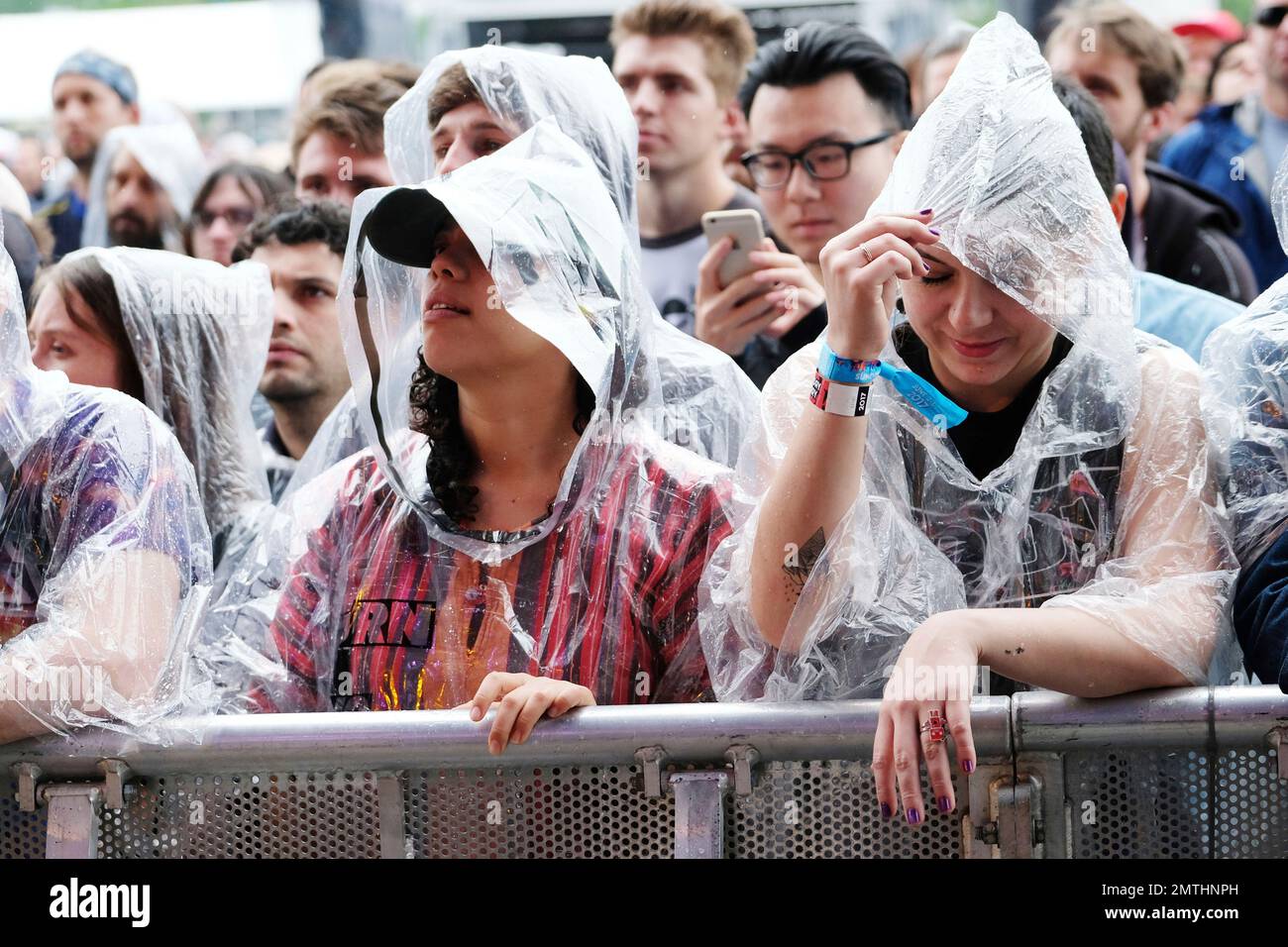 Concert goers are seen in the rain on day three of the Governors Ball ...