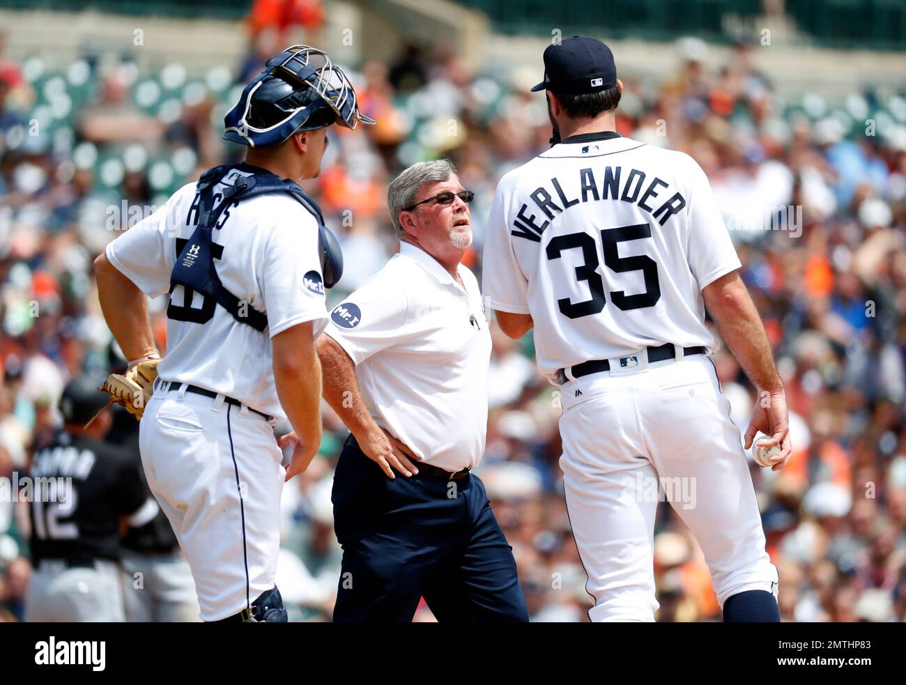 Detroit Tigers trainer Kevin Rand checks on pitcher Justin Verlander ...