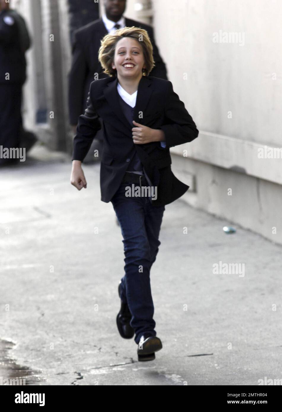 Super 8 actor Ryan Lee runs to greet fans and photographers outside the ...