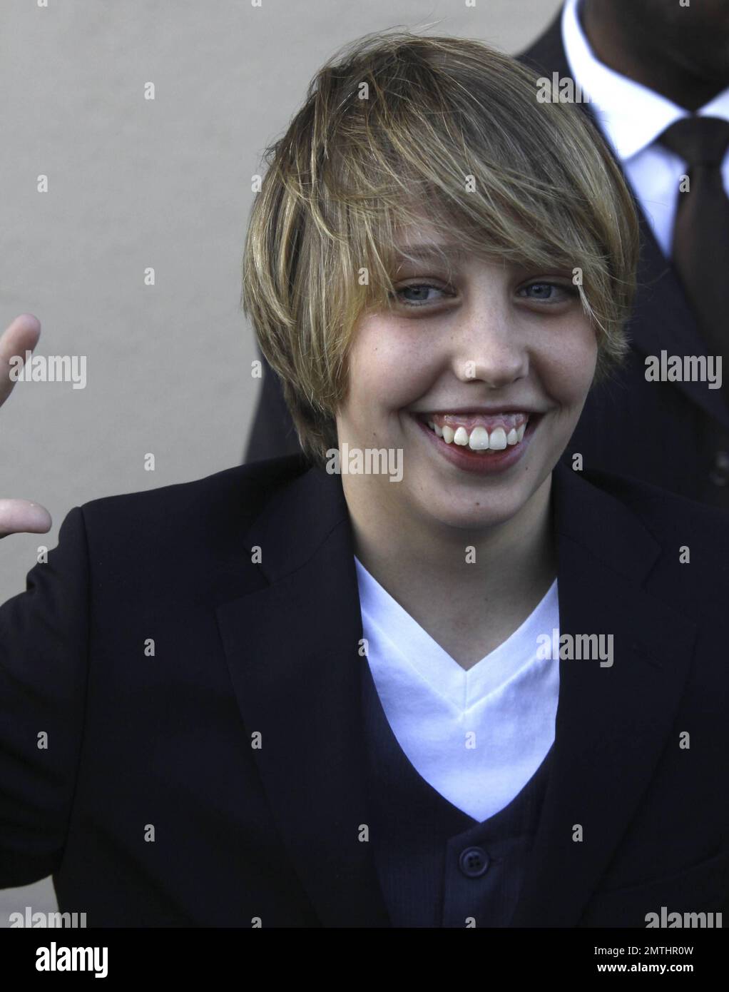 Super 8 actor Ryan Lee runs to greet fans and photographers outside the ...