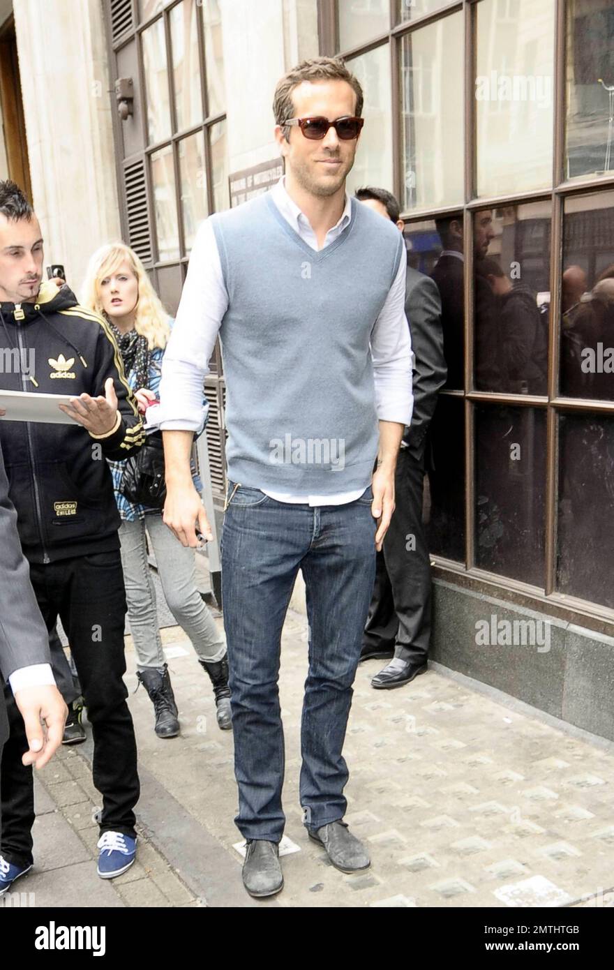 "Green Lantern" star Ryan Reynolds wears a sweater vest and jeans as he ...