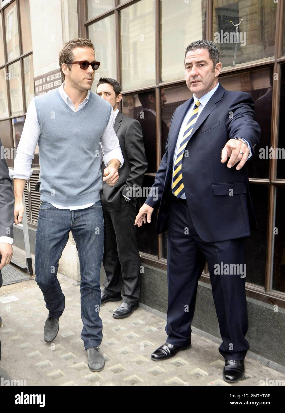 "Green Lantern" star Ryan Reynolds wears a sweater vest and jeans as he ...