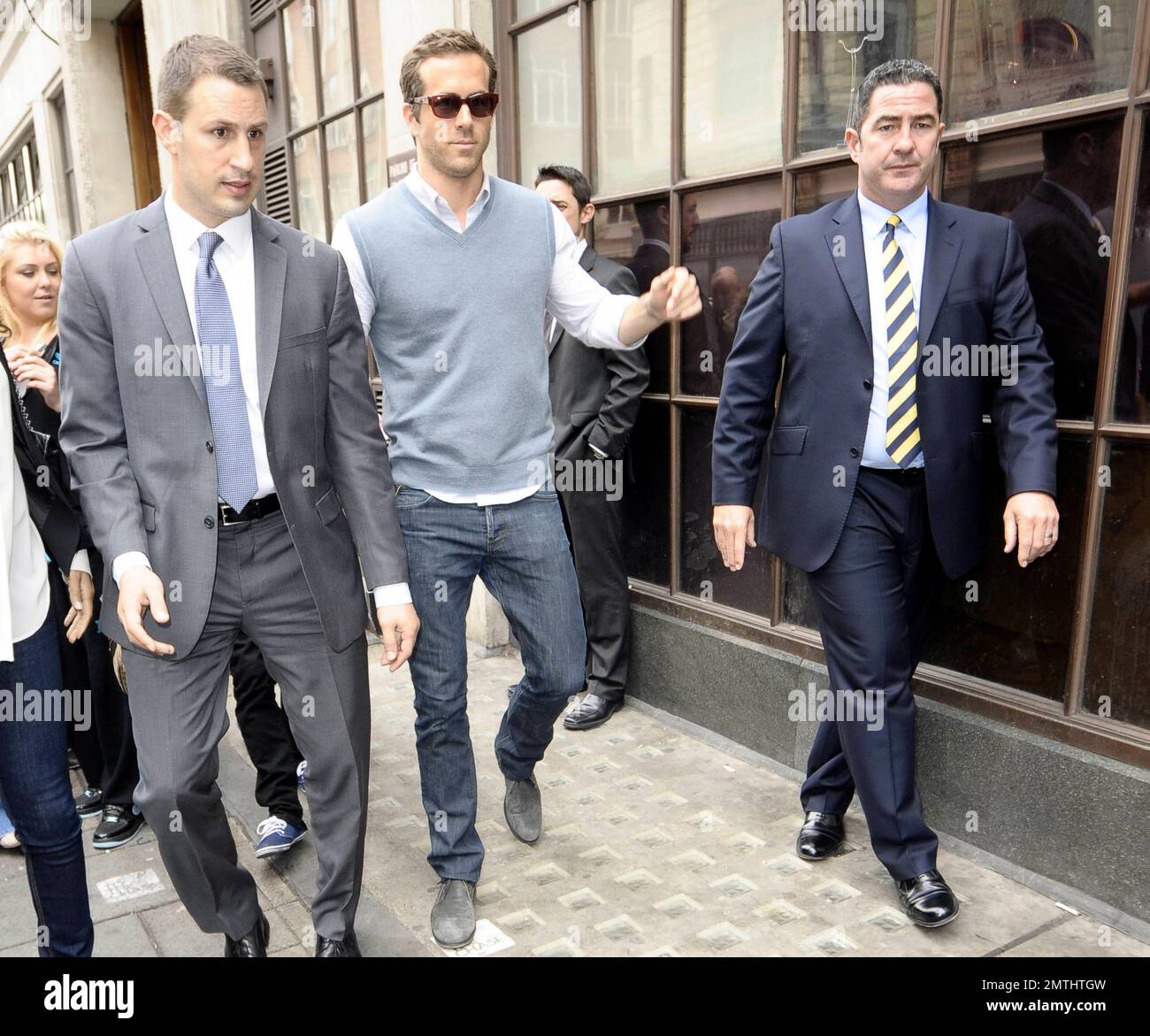 "Green Lantern" star Ryan Reynolds wears a sweater vest and jeans as he ...