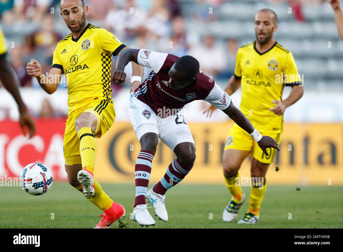 Columbus Crew forward Justin Meram, left, fights for control of the ...
