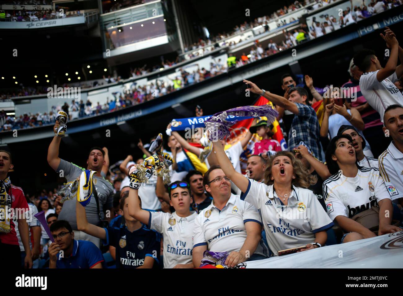 Real Madrid supporters celebrate their team's first goal as they watch ...