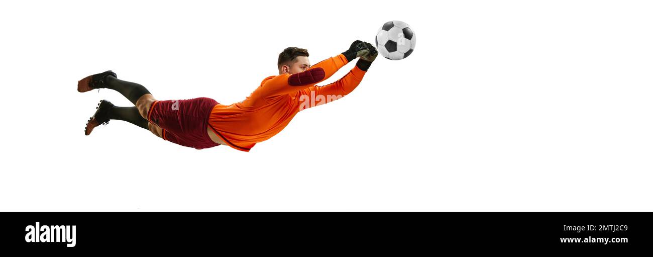 Dynamic portrait of professional soccer goalkeeper jumping and catching ...