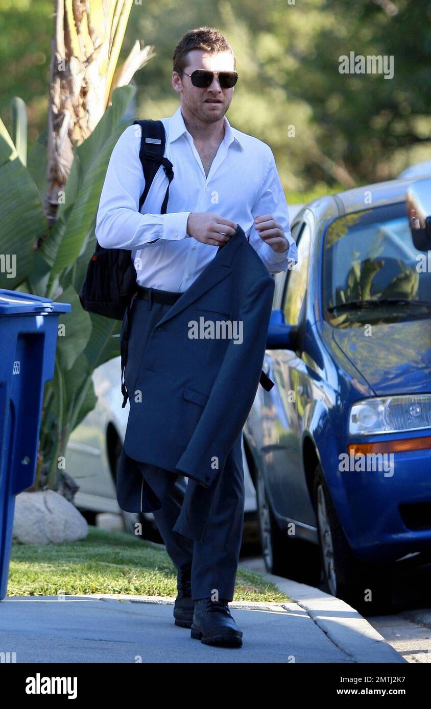 EXCLUSIVE!! A smartly dressed Sam Worthington leaves his home with bags ...
