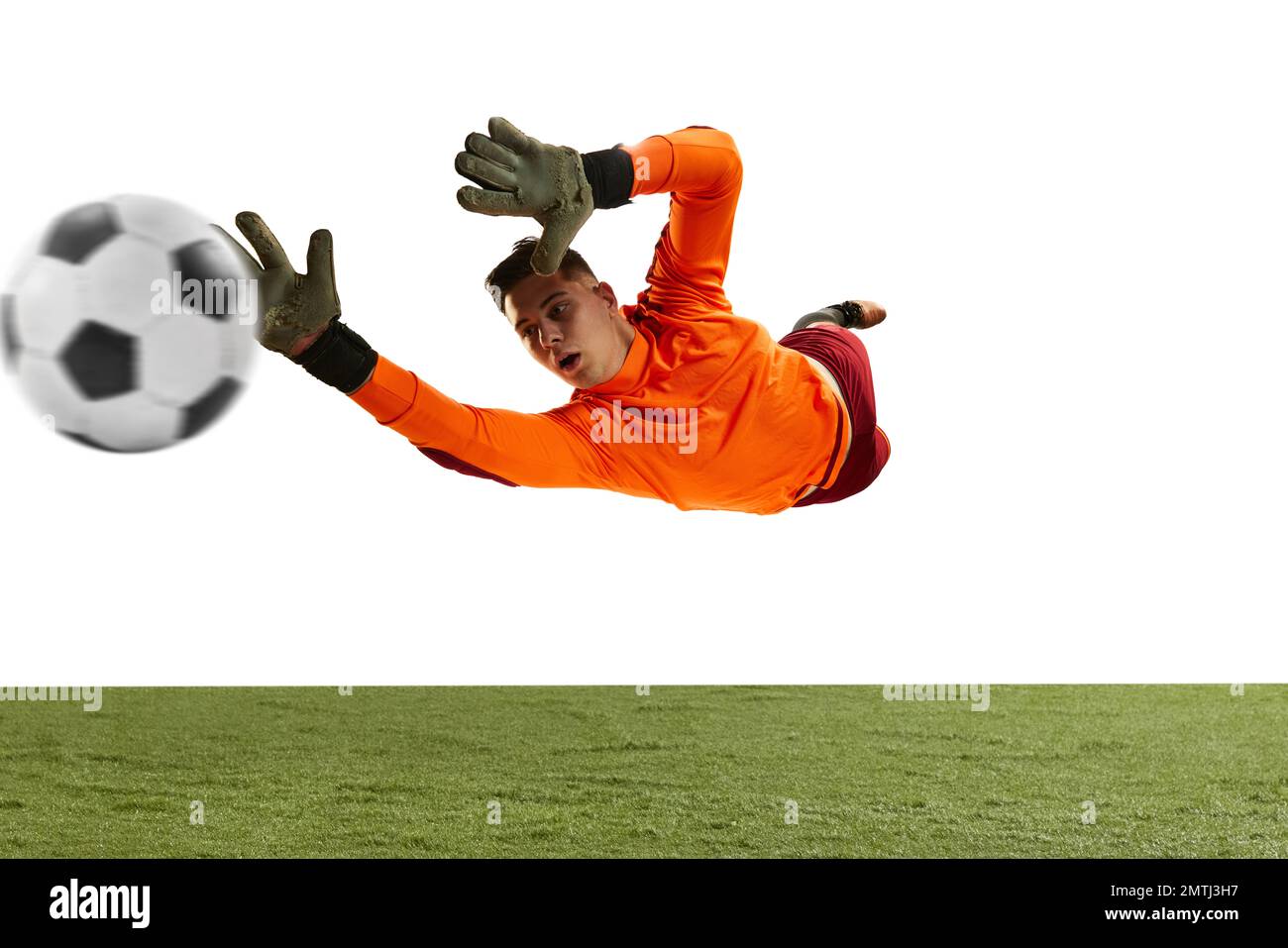 Dynamic portrait of professional soccer goalkeeper jumping and catching ...