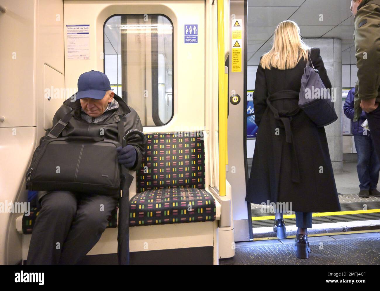 London, England, UK. London Underground: young woman and older man in a ...