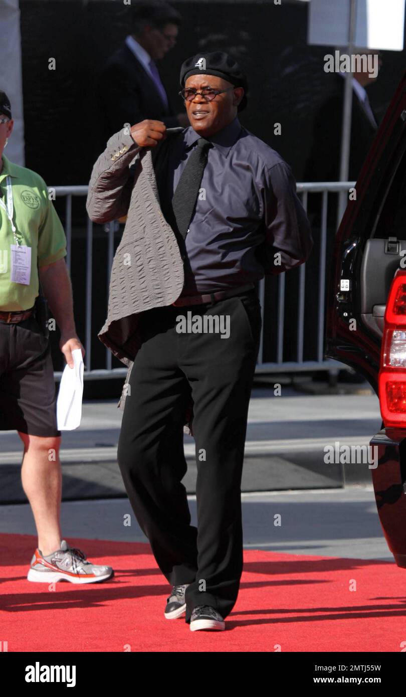 Actor Samuel L. Jackson puts his jacket on after getting out of a black ...