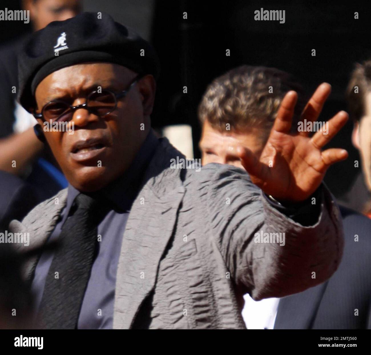 Actor Samuel L. Jackson puts his jacket on after getting out of a black ...