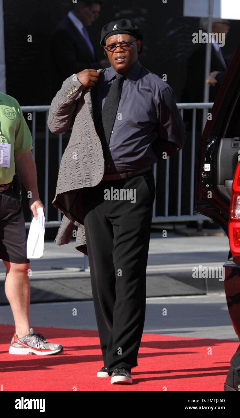 Actor Samuel L. Jackson puts his jacket on after getting out of a black ...