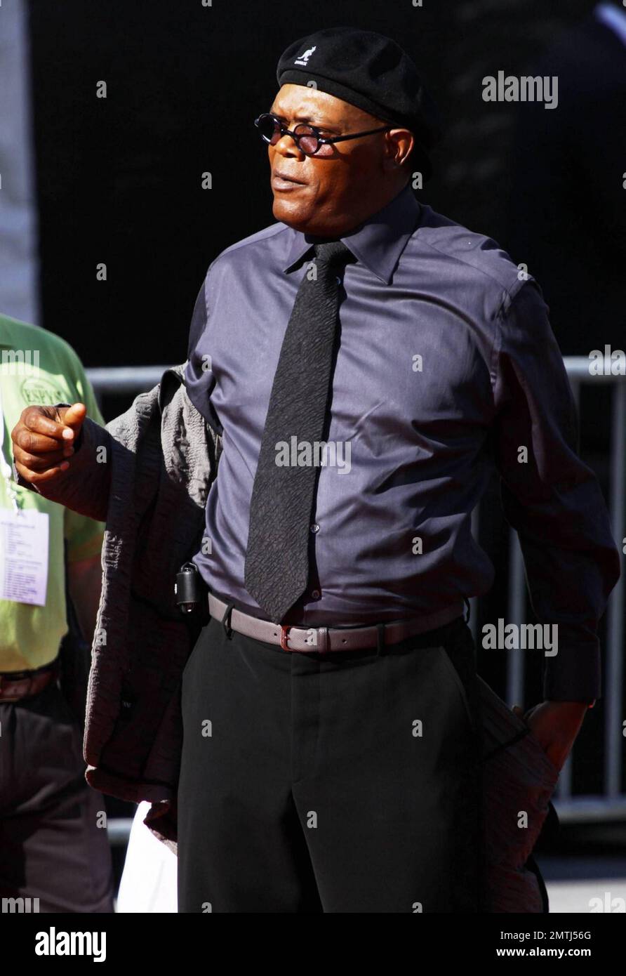 Actor Samuel L. Jackson puts his jacket on after getting out of a black ...