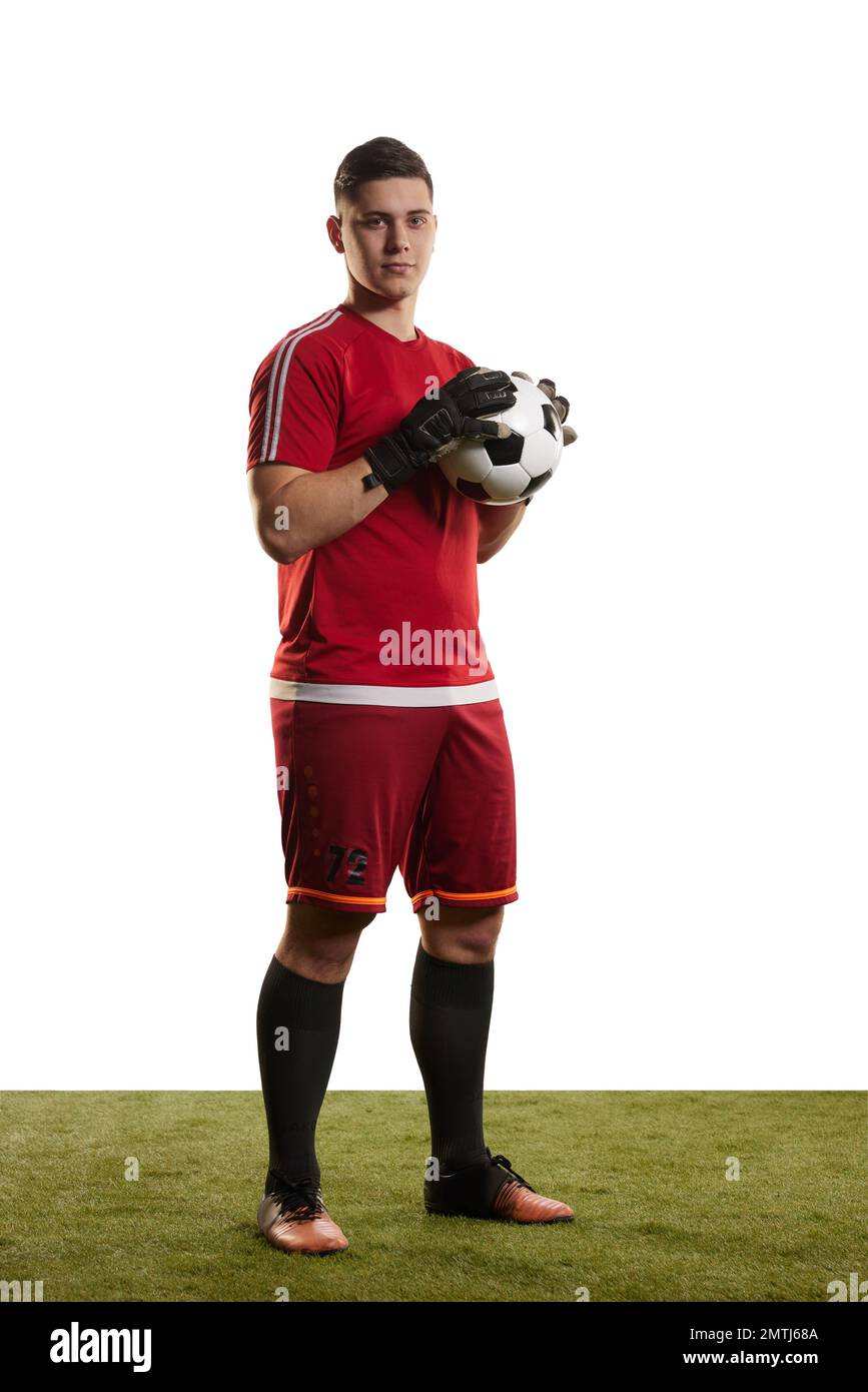 Young caucasian football player, male soccer goalkeeper wearing red ...