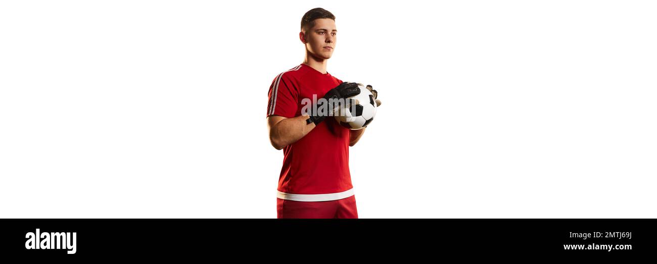 Young caucasian football player, male soccer goalkeeper wearing red ...