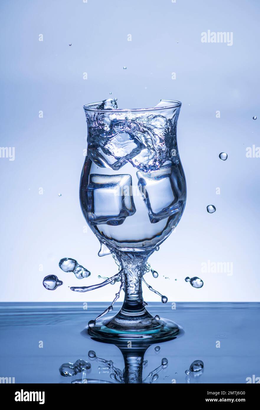 The image of pouring drinking water, into a broken glass, that makes ...