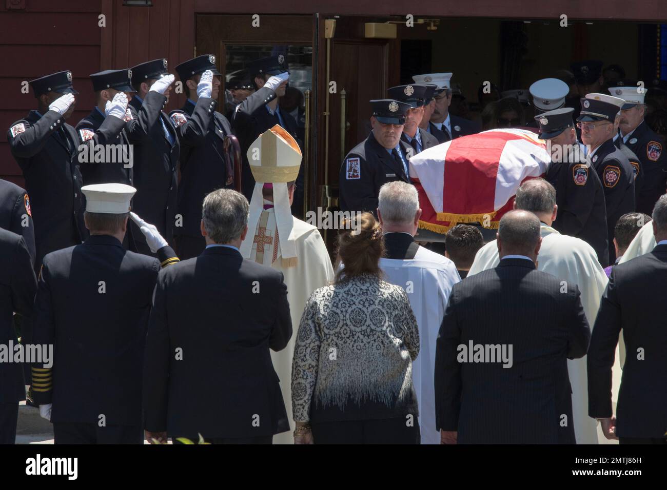 Firefighters and salute as the casket carrying retired New York City ...