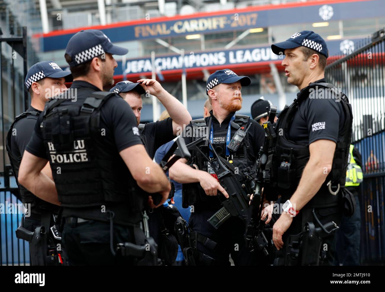 Armed police officers stand guard outside the Millennium Stadium in ...