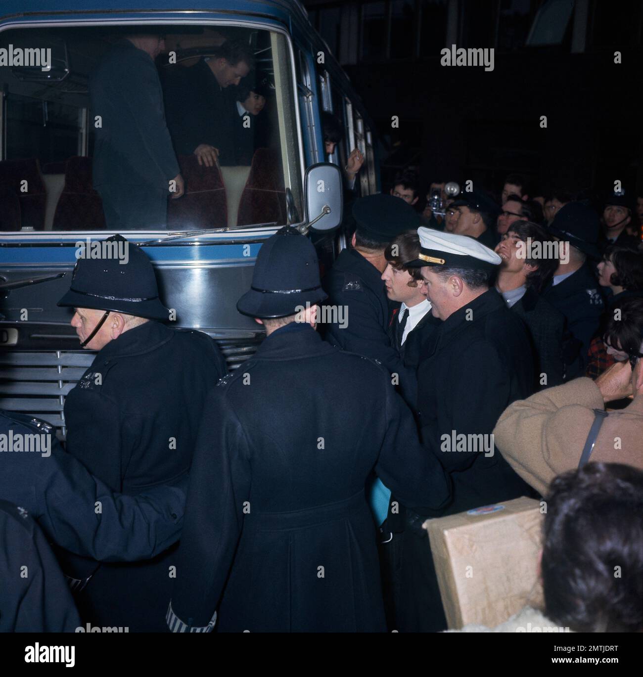Police protect members of popular rock band, the Beatles, upon their ...