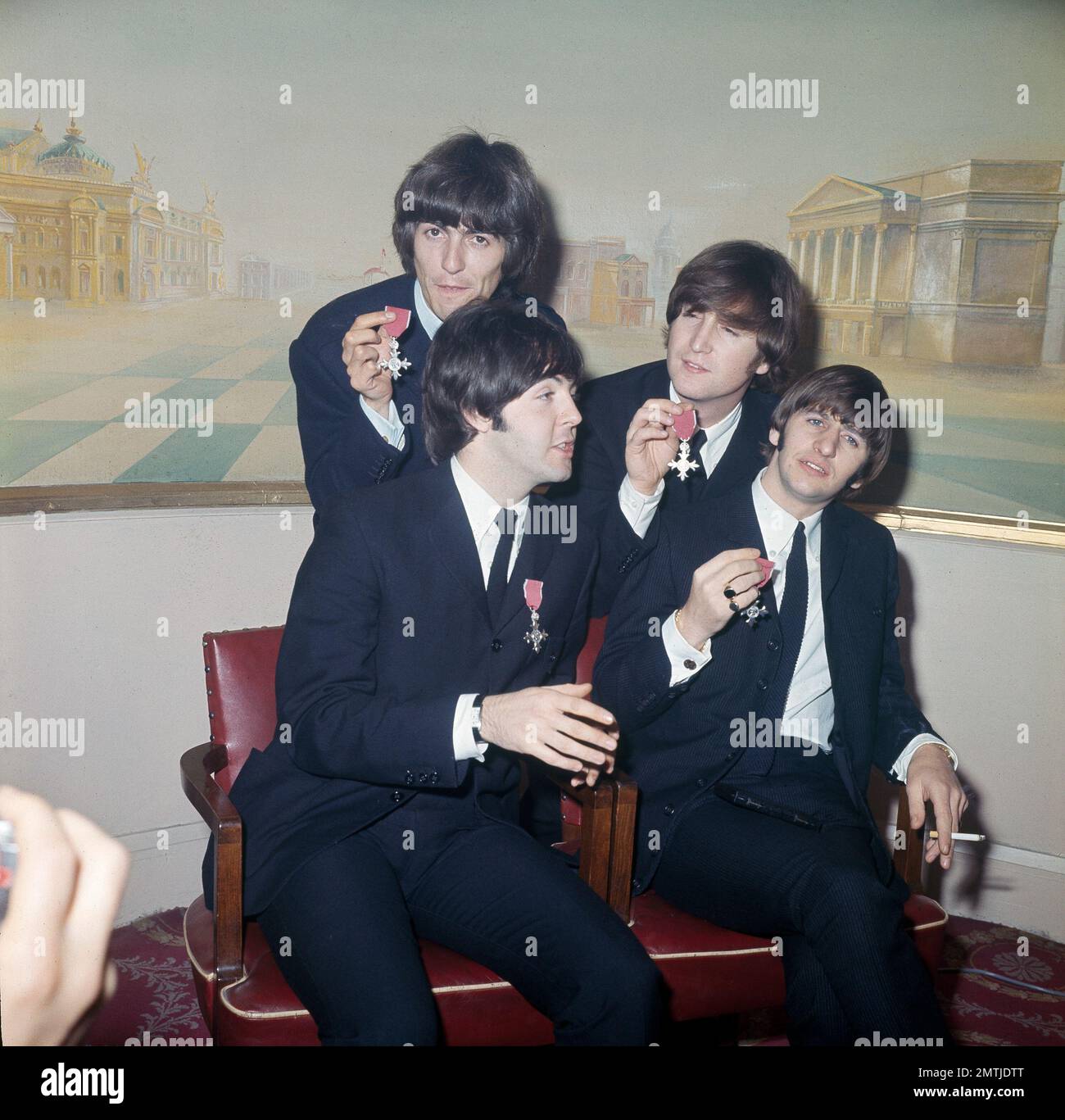 The Beatles show their medals during a news conference in London, Oct ...