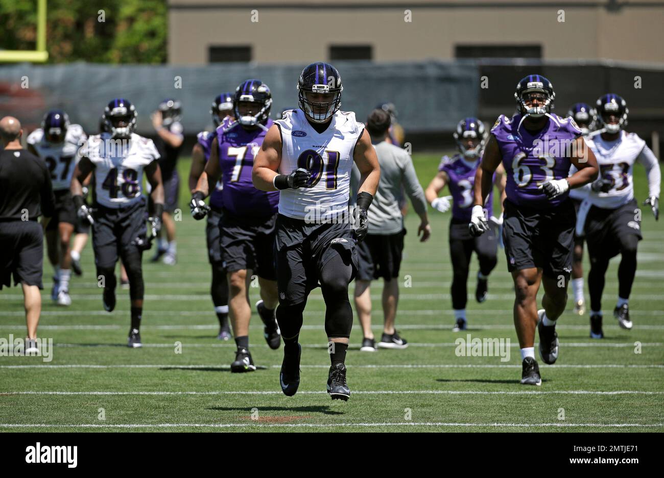Baltimore Ravens defensive end Patrick Ricard runs alongside teammates ...