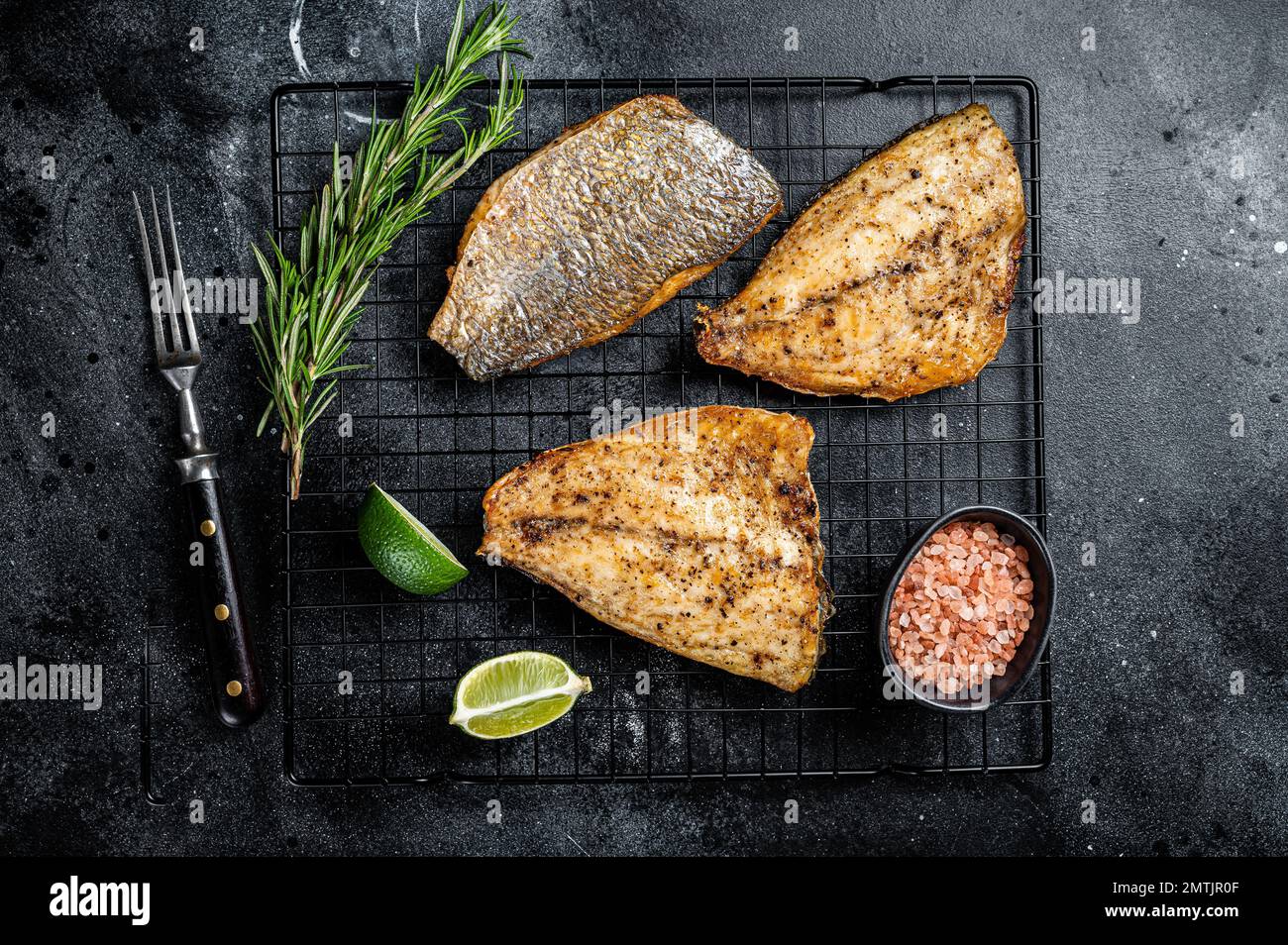 Baked Dorado Sea Bream fillets. Black background. Top view Stock Photo ...