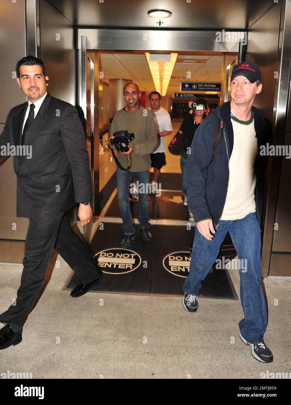 Actor Sean Hayes makes his way through Miami International Airport ...