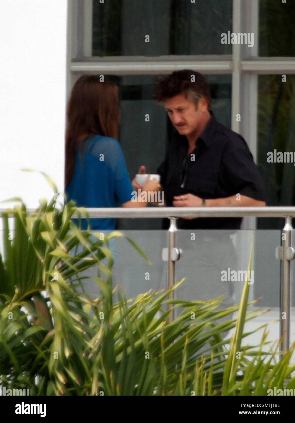 Academy Award-winning actor Sean Penn sips coffee and smokes a ...