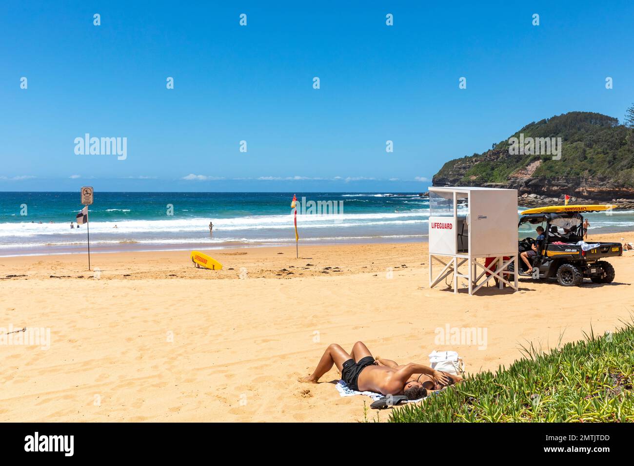 Australian lifeguard service and couple sunbathing on Warriewood beach ...