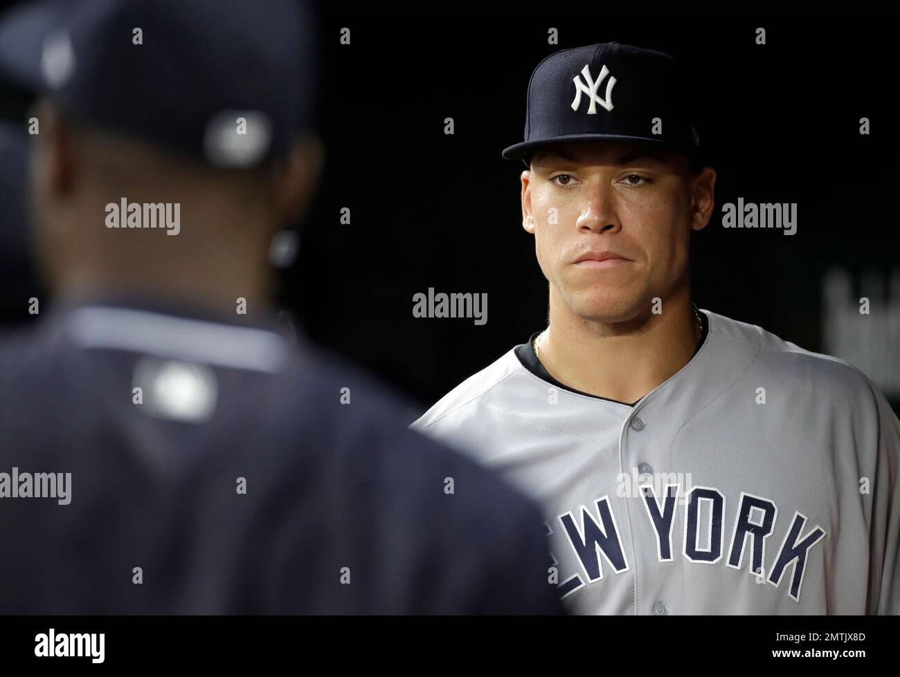 New York Yankees' Aaron Judge stands in the dugout before a baseball ...