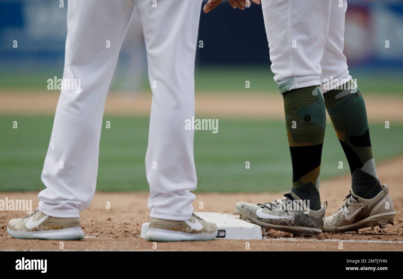 San Diego Padres first base coach Johnny Washington, left, fashions the ...