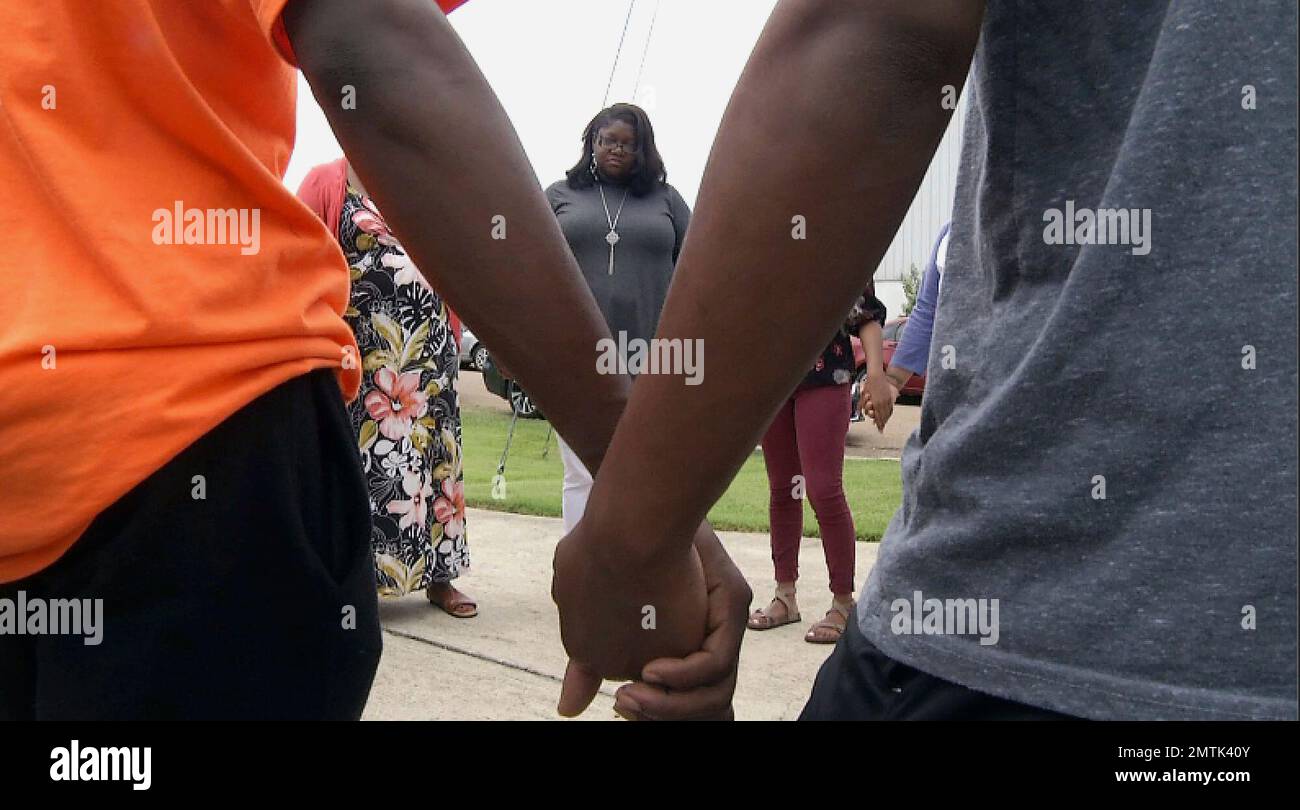 In this image made from a video, Shayla Edwards, center, and other ...