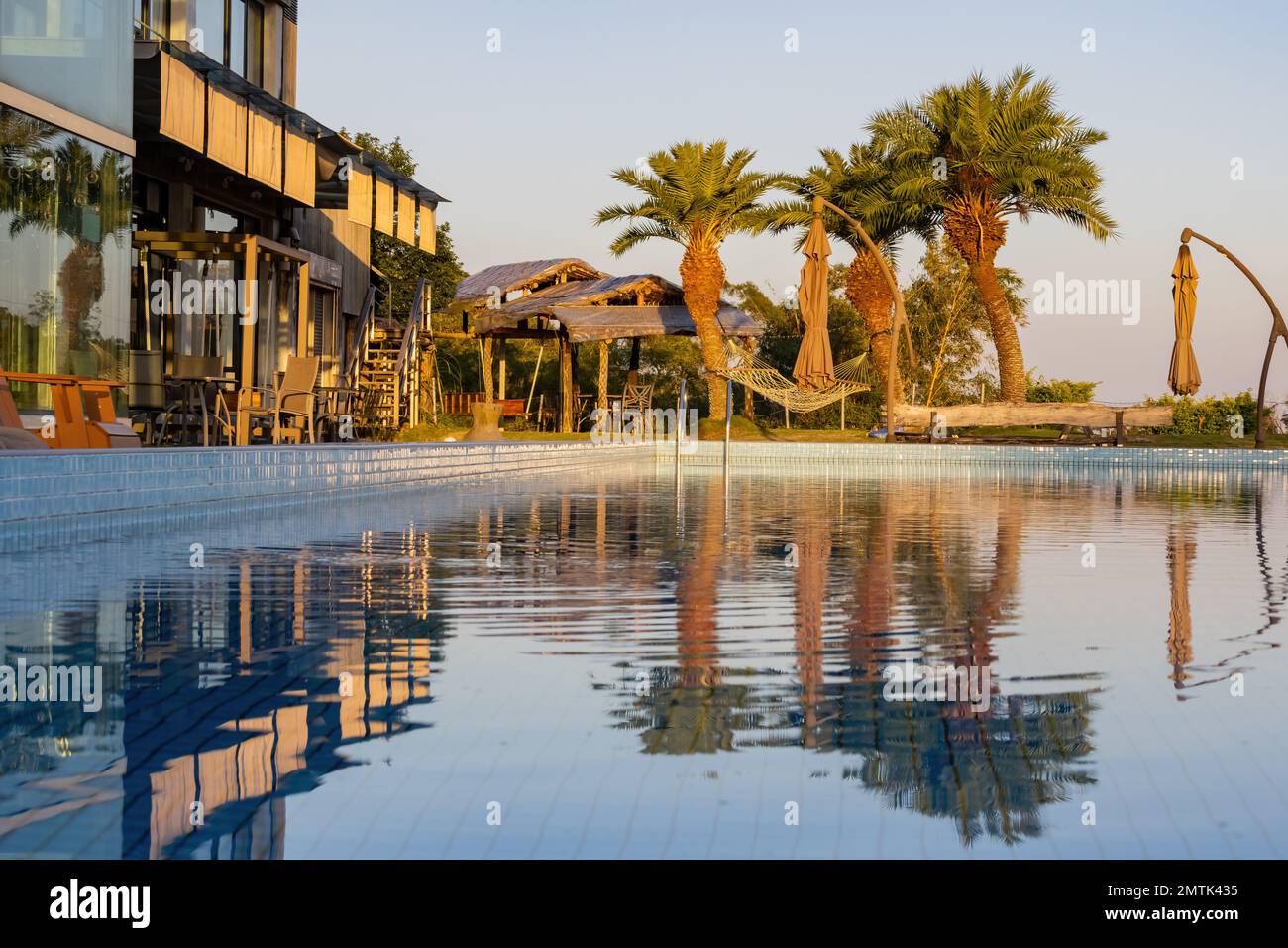 Sunny exterior view of the a swimming pool and tree landscape at Yilan ...