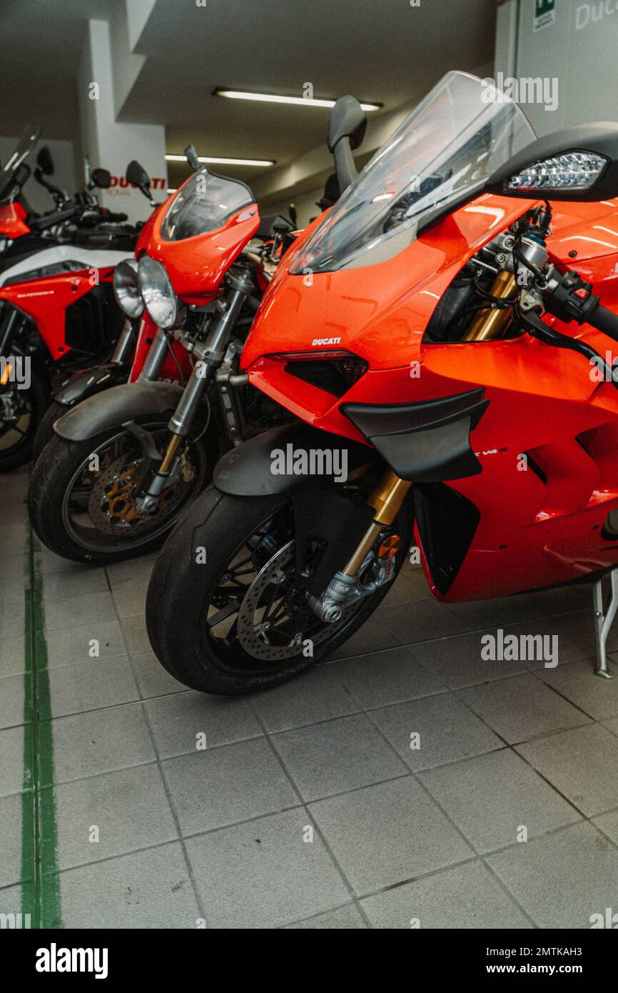 A vertical shot of red motorcycles in a store Stock Photo - Alamy