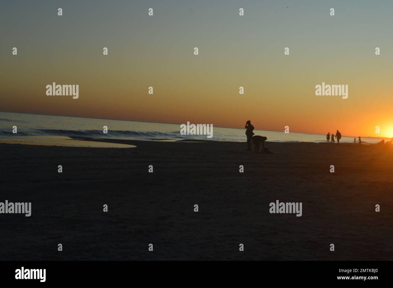 beautiful sunset on the beach of Uruguay, summer with silhouette of ...