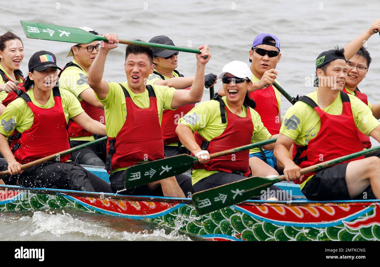 Members of a rowing team cheer after a traditional Chinese Dragon Boat ...