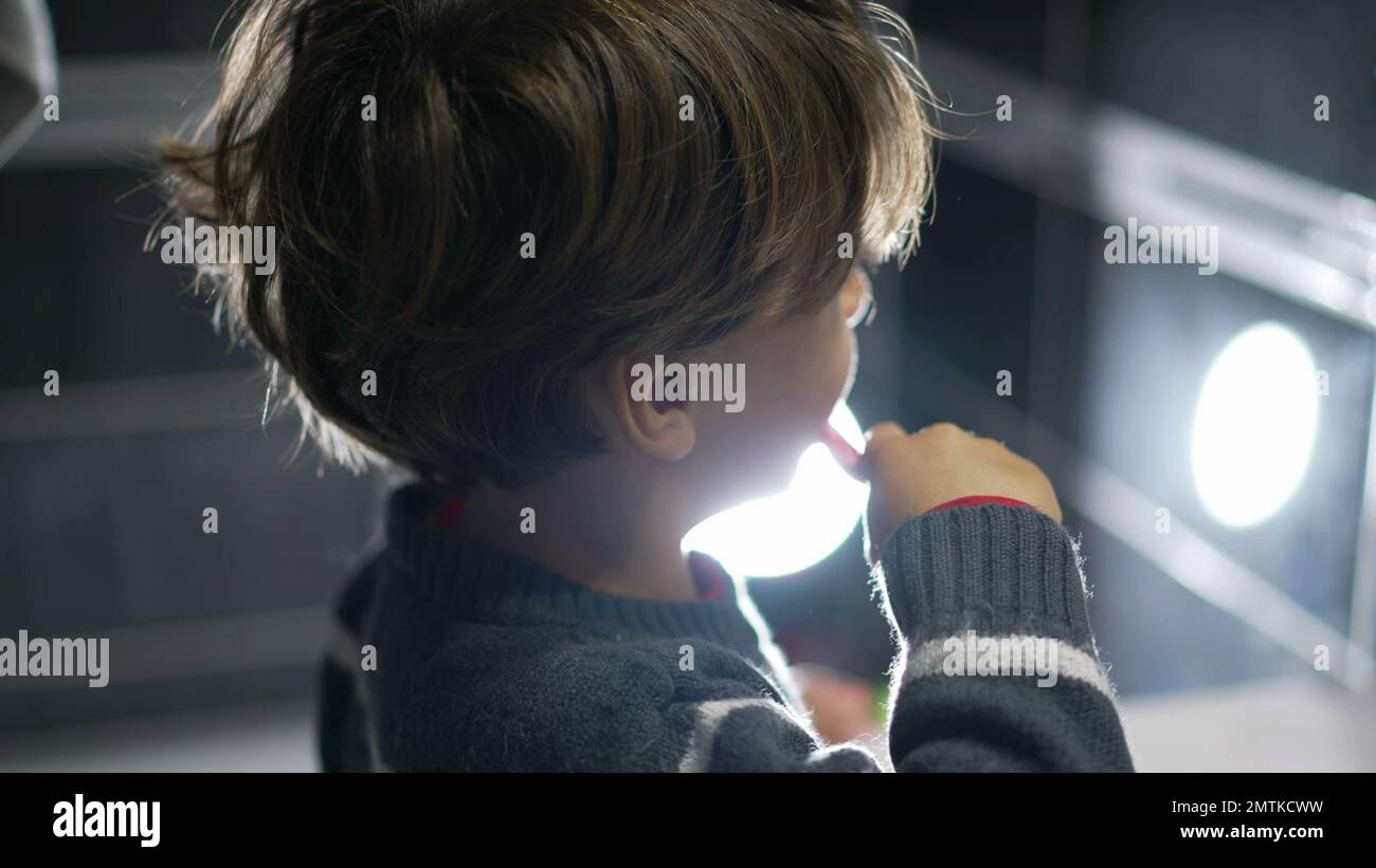 Child brushes teeth at night routine before bed. Little boy brushing ...