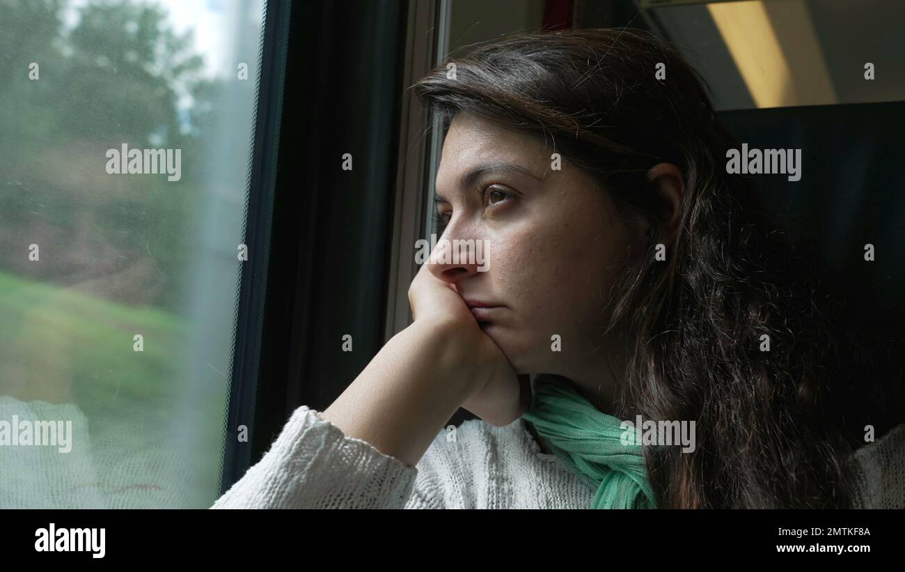 Female Passenger opening eyes while traveling by train looking at ...