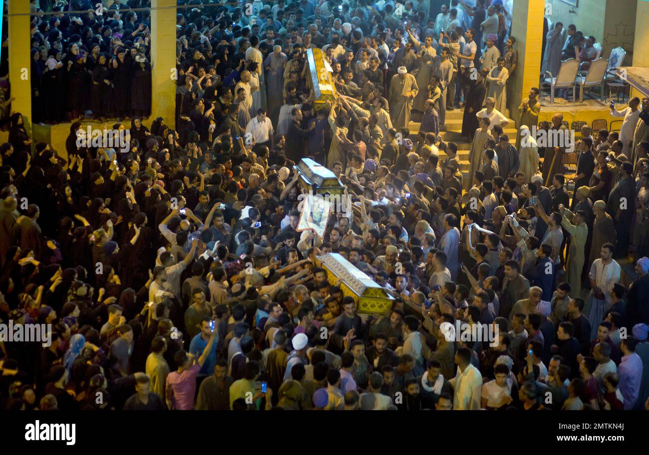 Relatives of Coptic Christians carry coffins of their relatives who ...