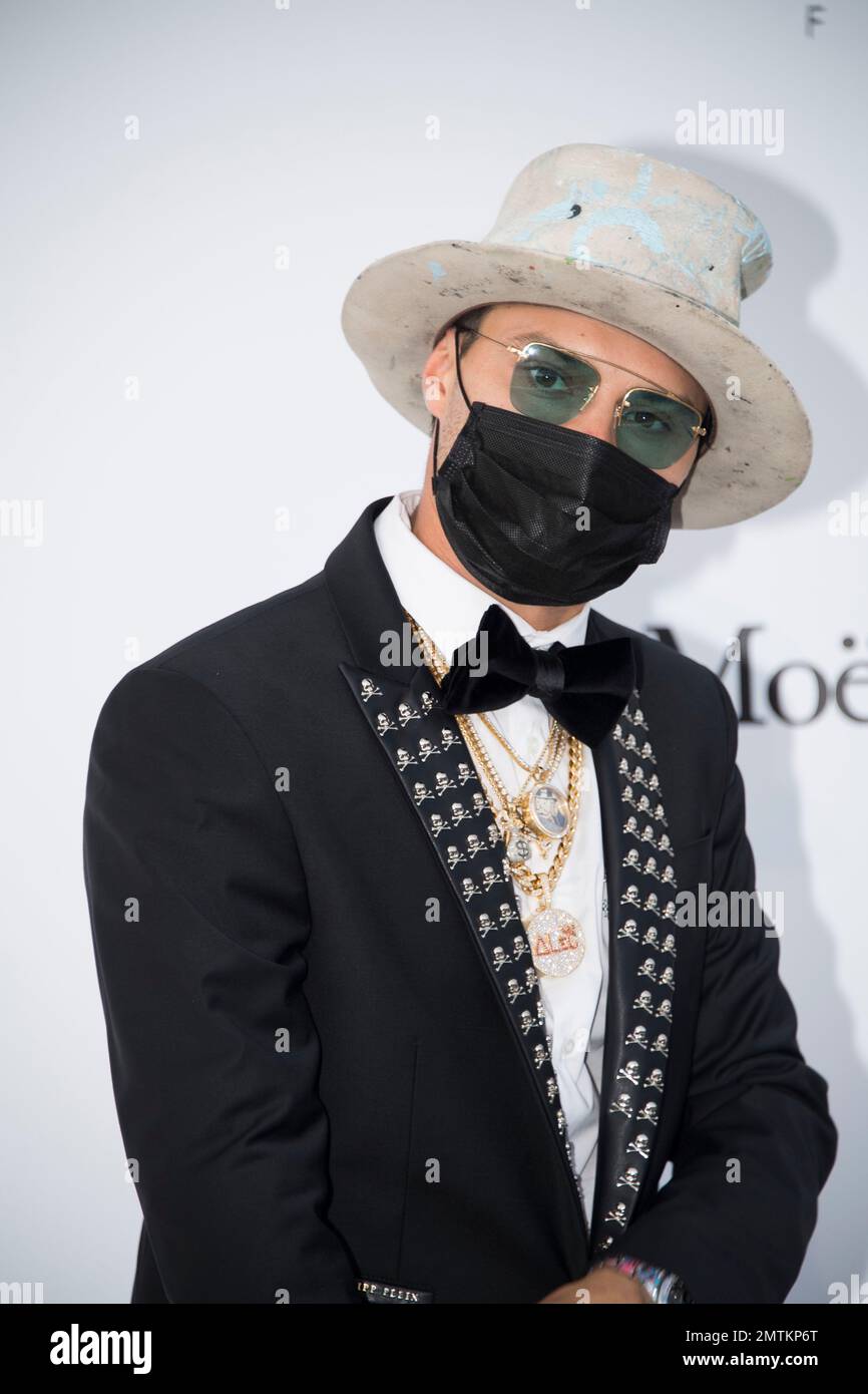 Alec Monopoly poses for photographers upon arrival at the amfAR charity ...
