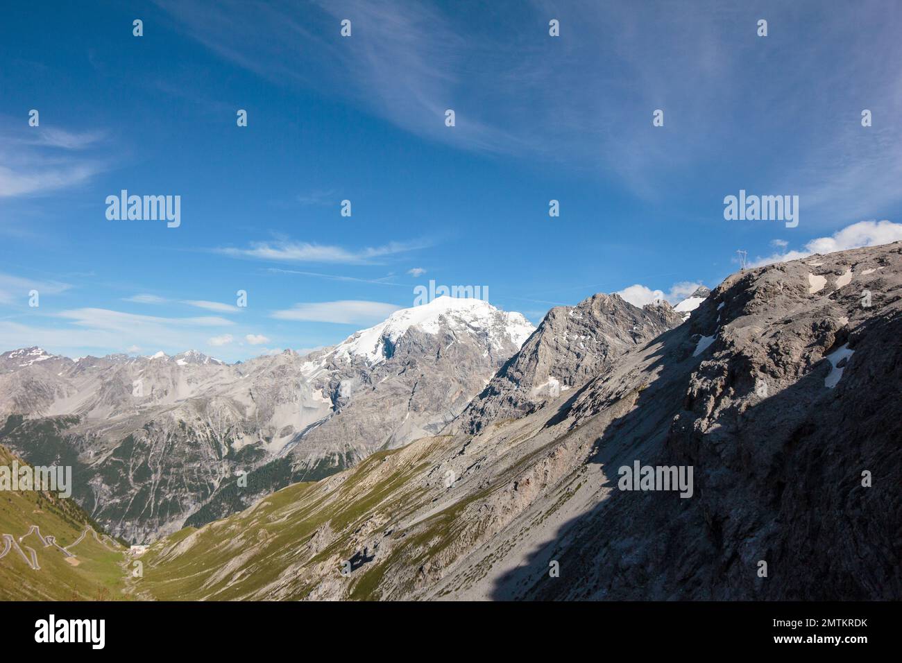 A beautiful view of a high peaky and rocky mountain pass on daytime ...