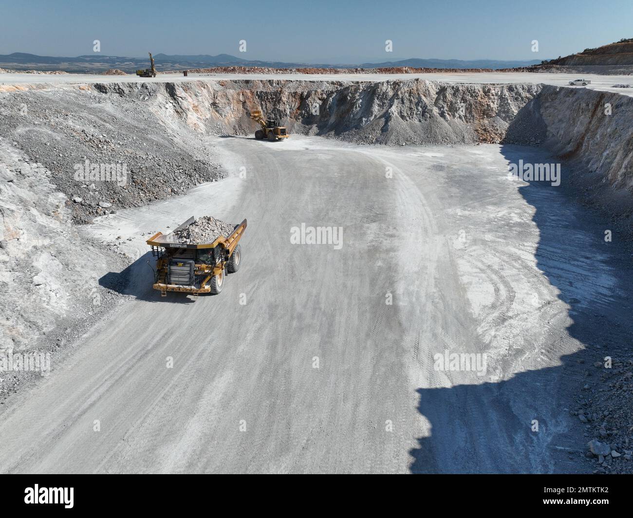 Work at a huge limestone quarry, wheel loader loading the dumper Stock ...