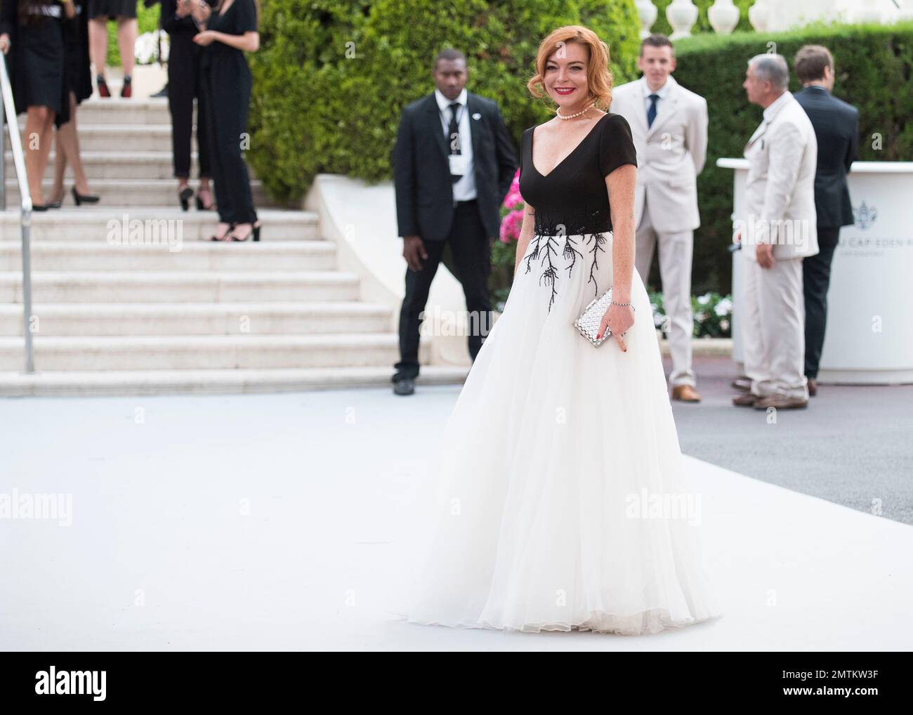 Lindsay Lohan poses for photographers upon arrival at the amfAR charity ...