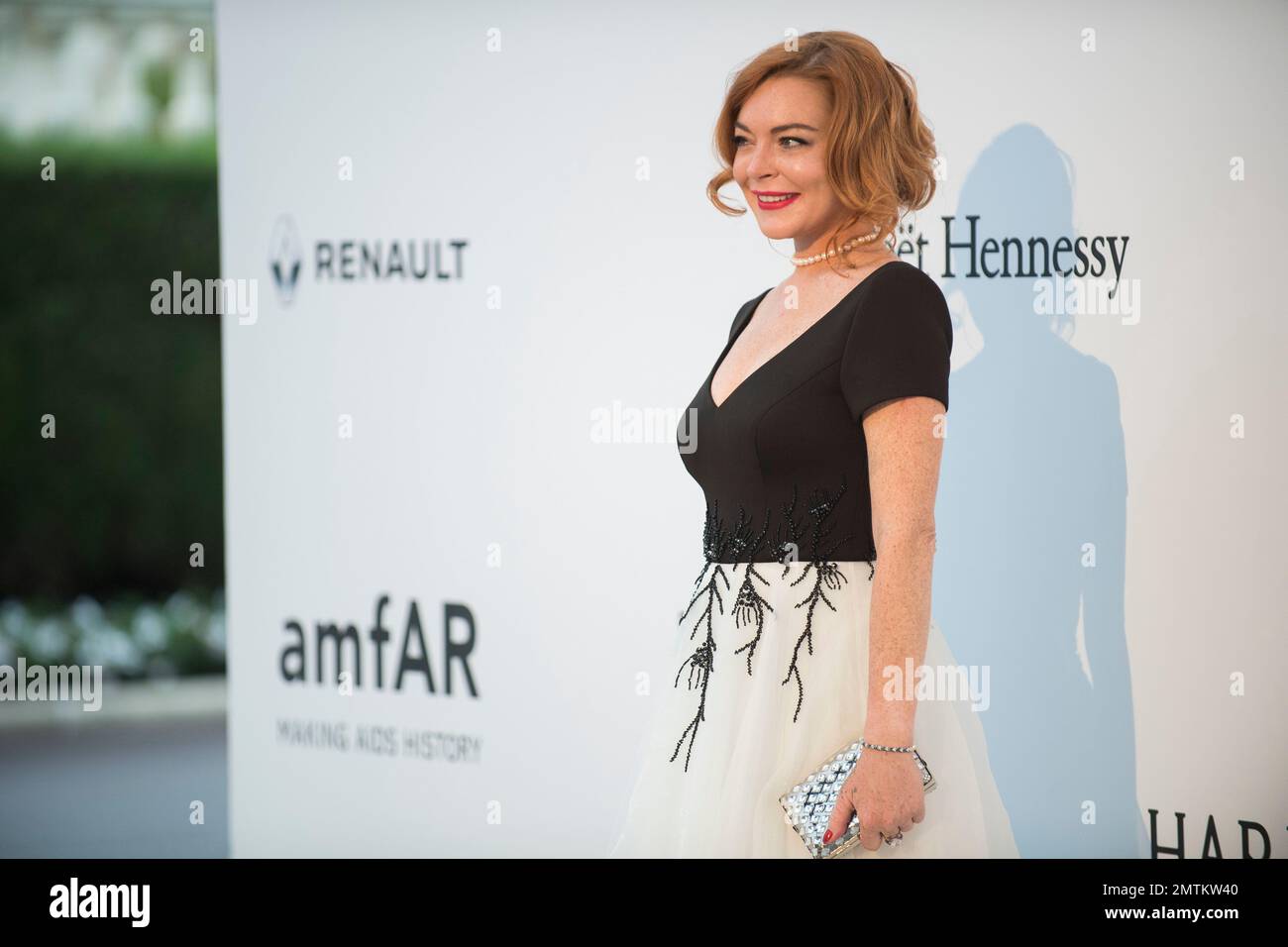 Lindsay Lohan poses for photographers upon arrival at the amfAR charity ...