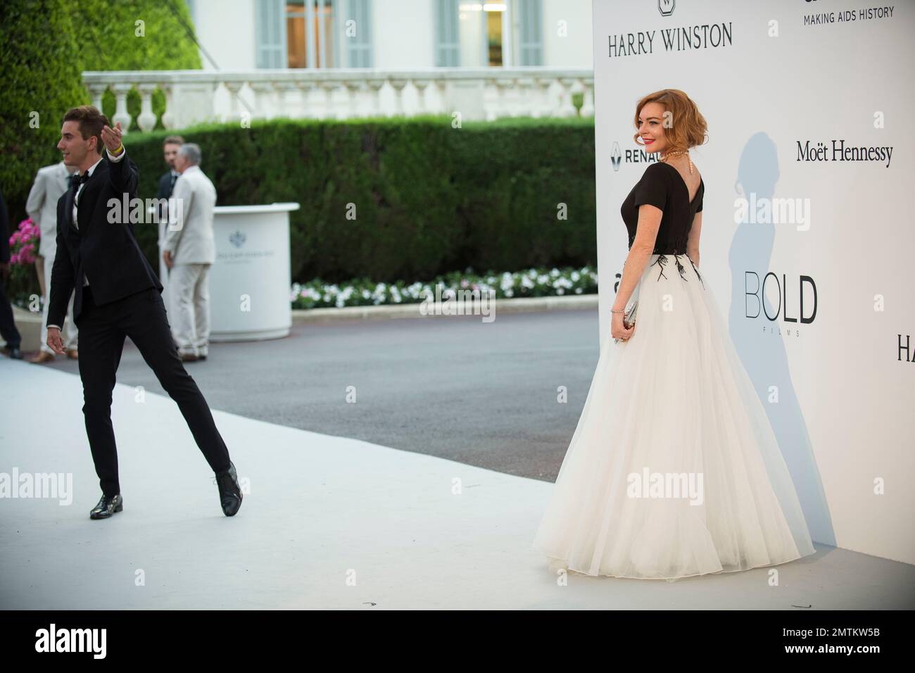 Lindsay Lohan poses for photographers upon arrival at the amfAR charity ...