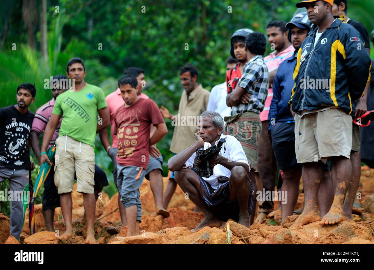 Sri Lankan landslide survivors watch military rescue efforts at Bellana village in Kalutara ...