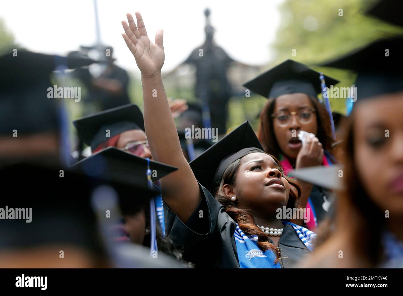 In this Saturday, May 13, 2017 photo, graduates react during a ...