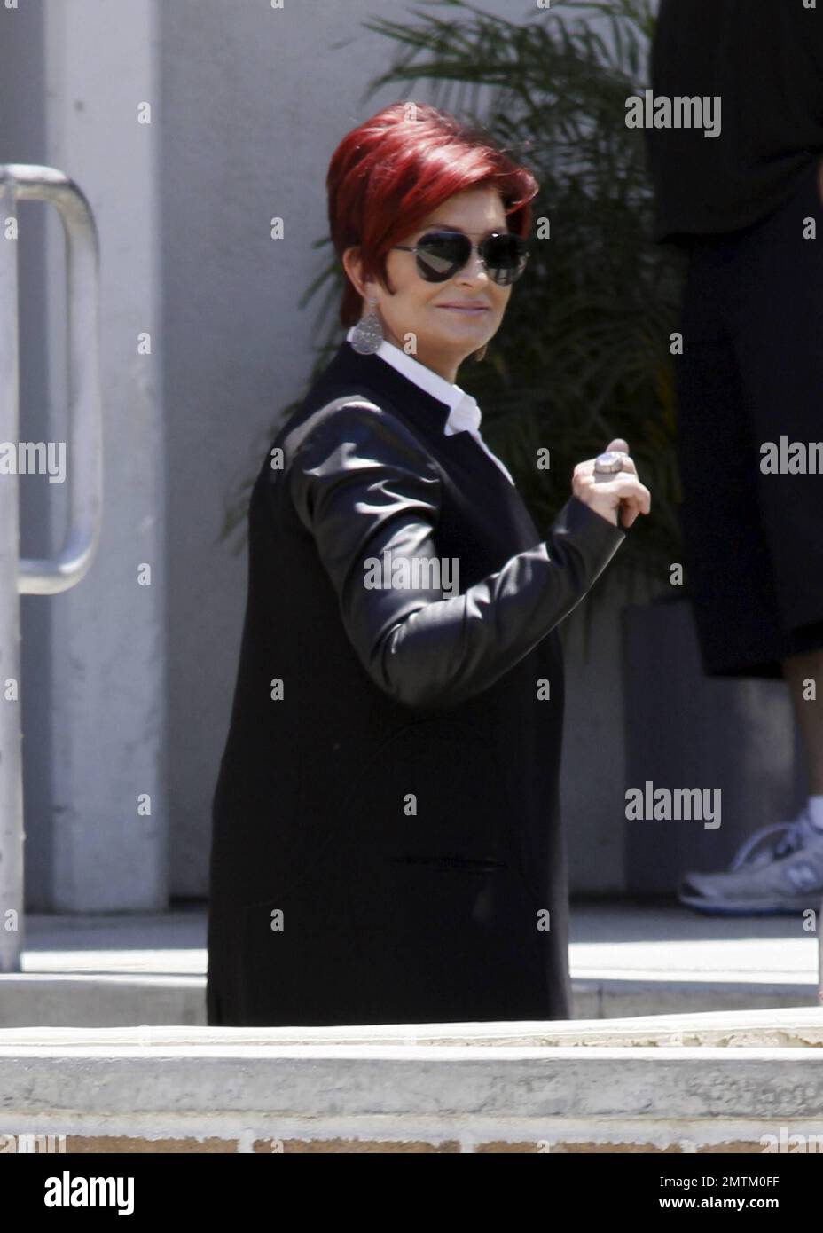 EXCLUSIVE!! Sporting bright-red hair and a long black suit, "America's ...